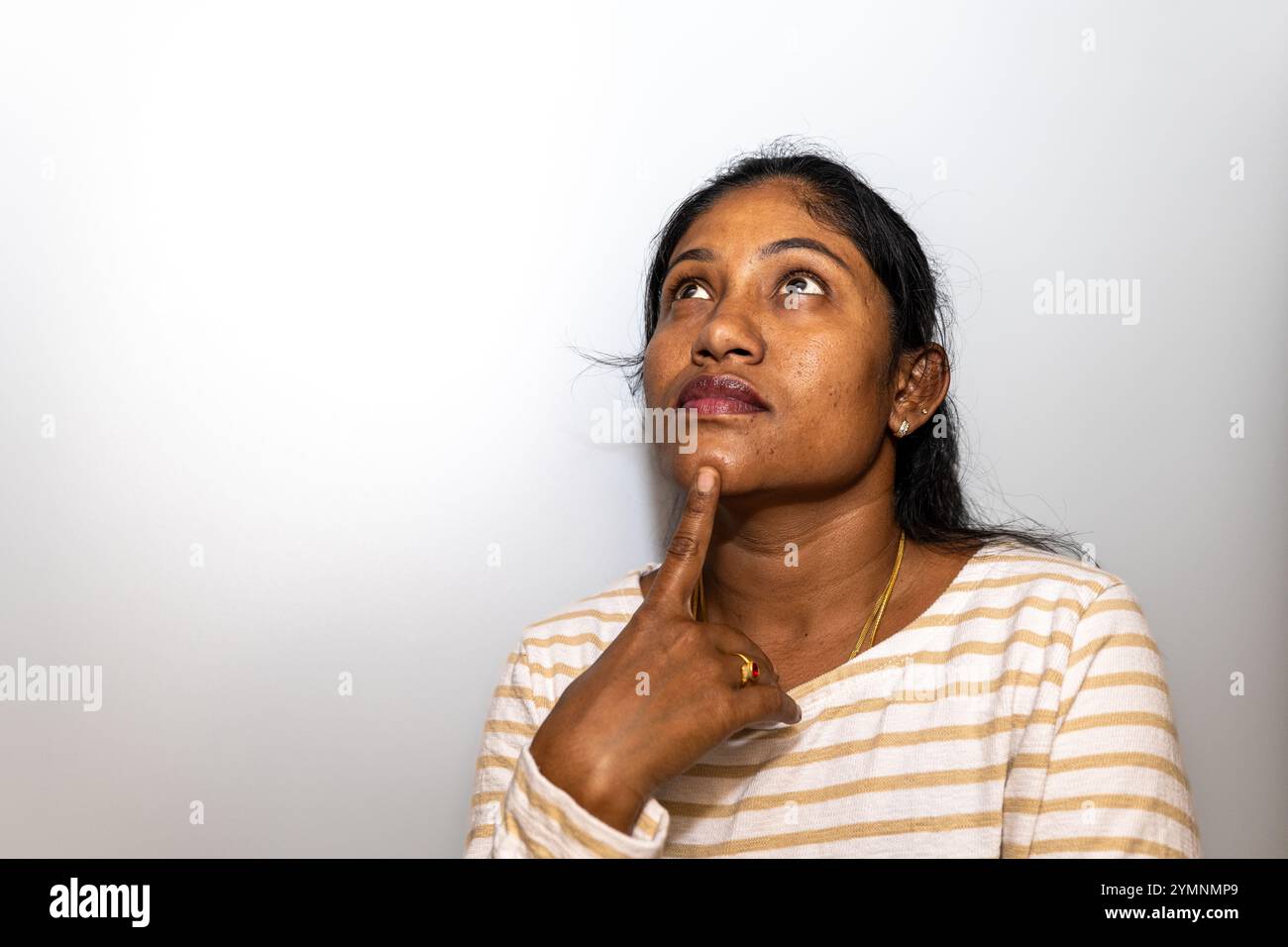 Woman contemplates, lost in thought, pondering a solution Stock Photo ...