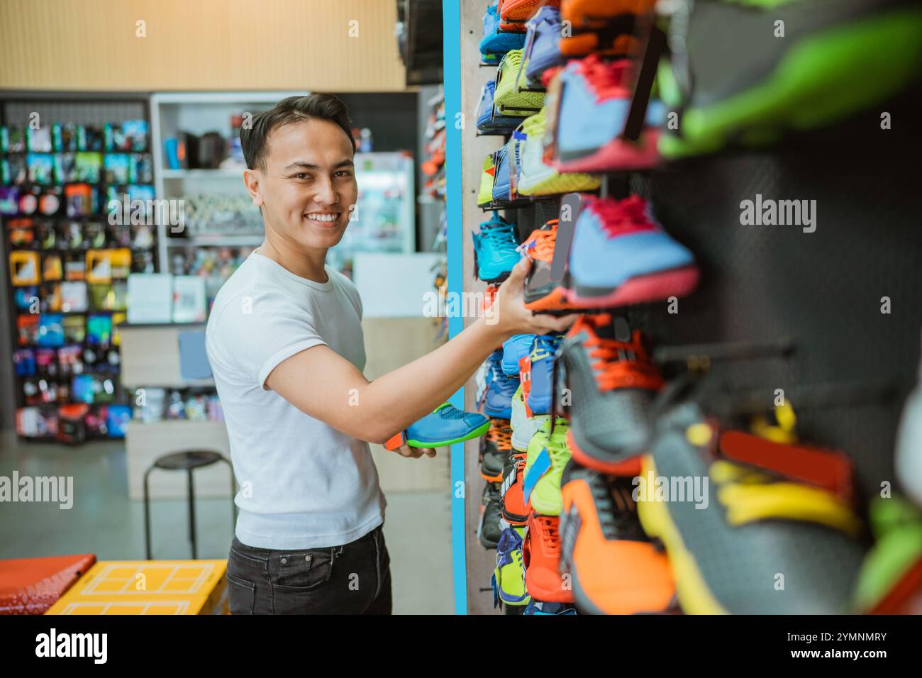 asian athletic footwear staff arranging shoes Stock Photo - Alamy
