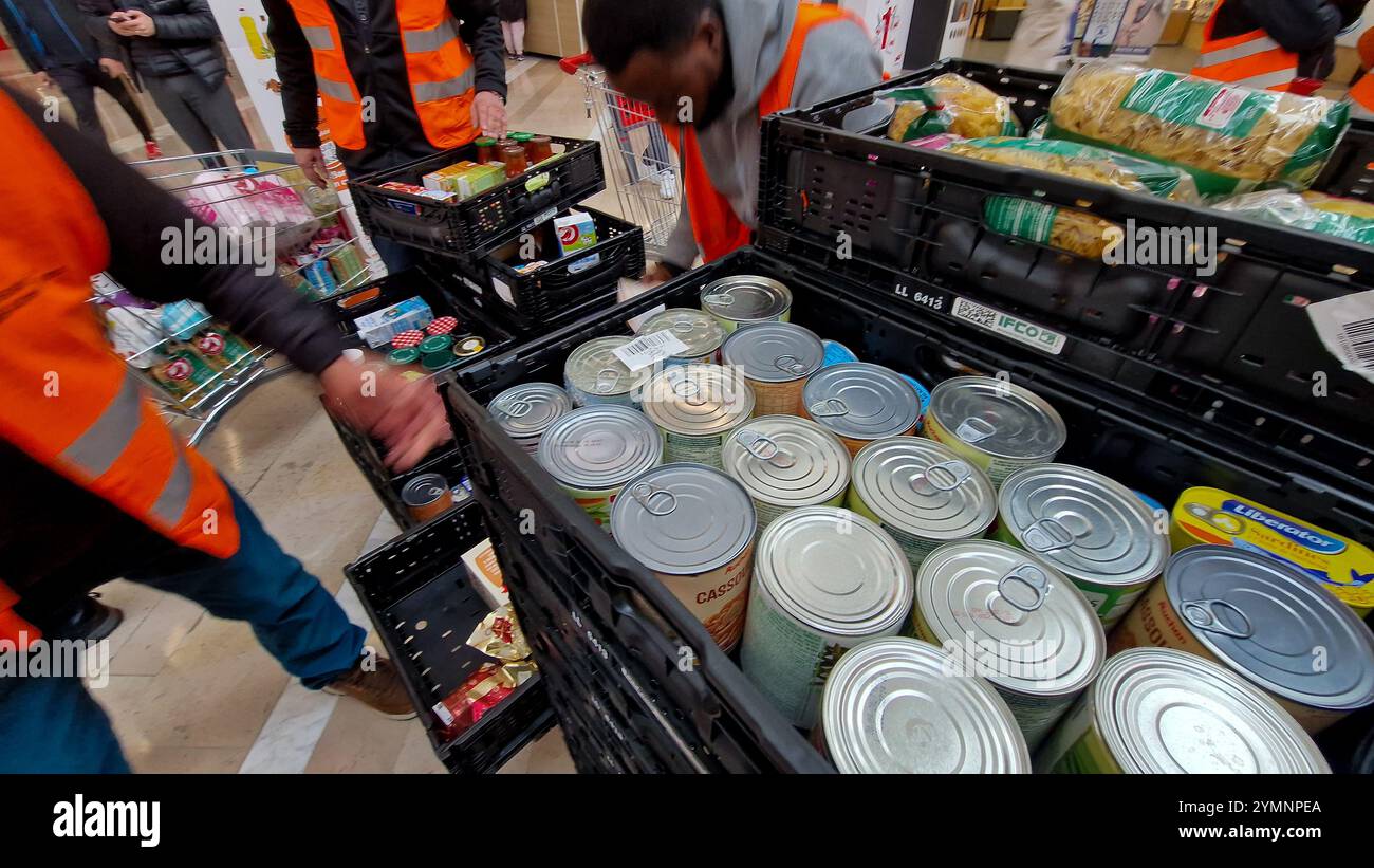 Voluntaries take part in a food collect to the benefit of French ...