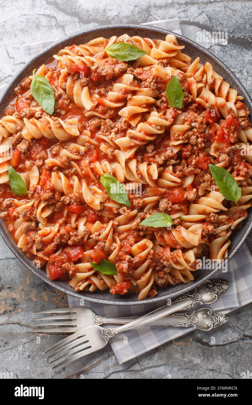 Fusilloni bolognese pasta with a hearty meat tomato sauce closeup on ...