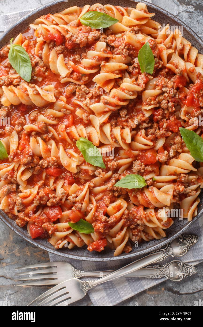 Bolognese pasta Fusilli with tomato sauce, ground minced beef, basil ...