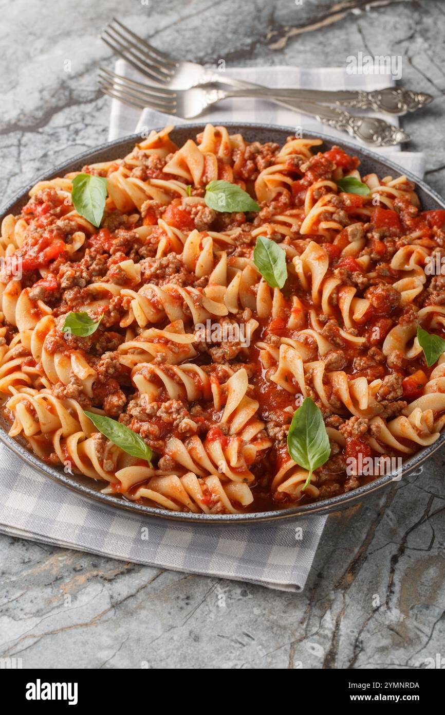 Italian Big Fusilloni bolognese pasta with a beef tomato sauce closeup ...