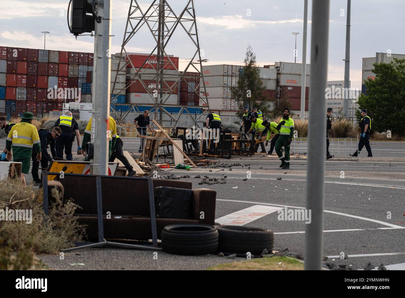 Police offers and truck drivers cleaning up the street during the ...