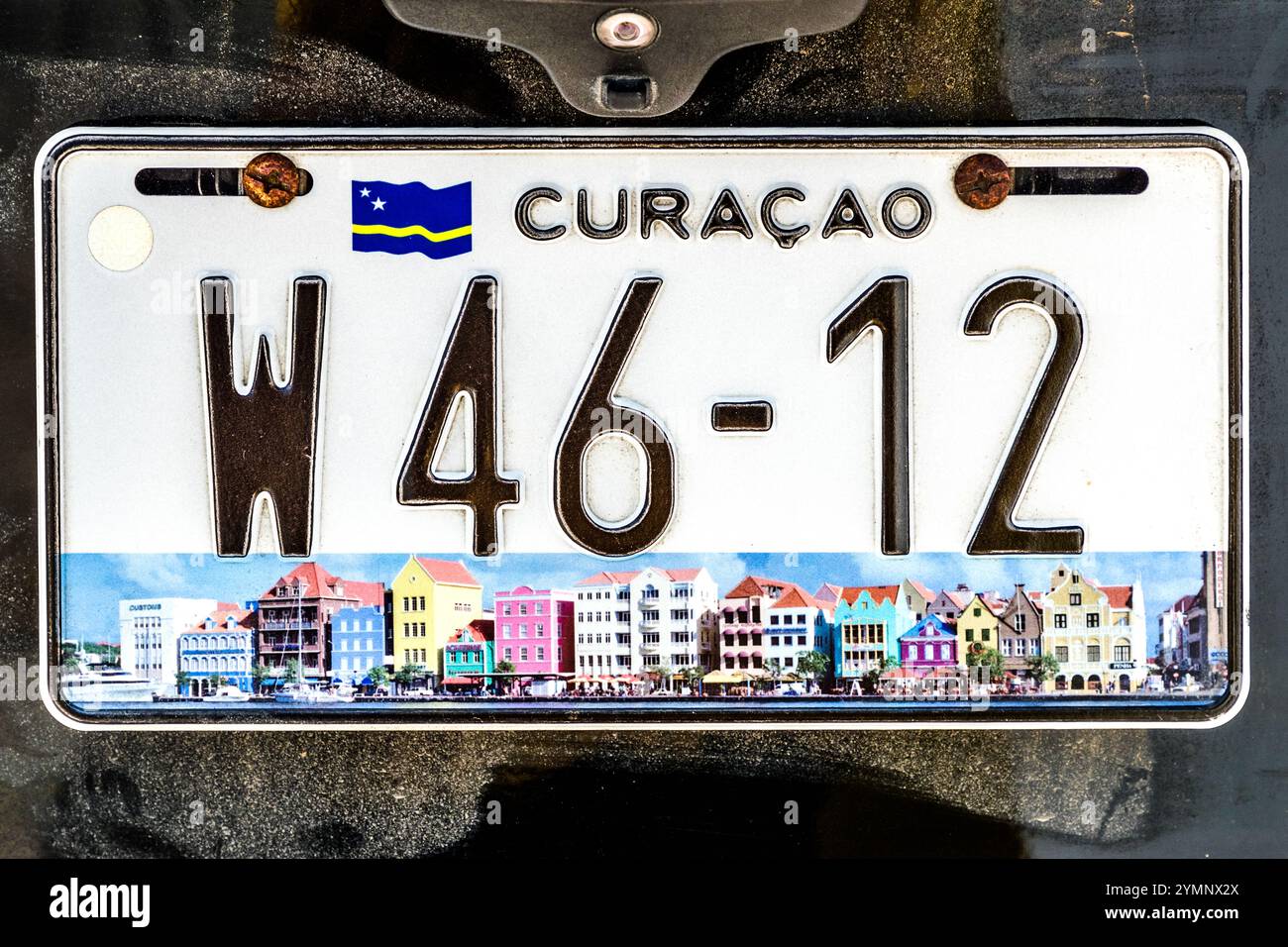 In Curaçao, the license plates of the cars show the national flag and ...