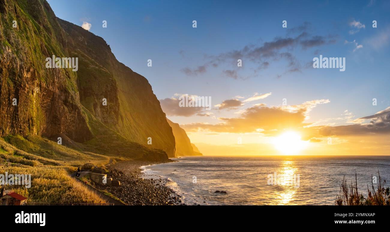 Volcanic rock cliffs Achadas da Cruz in backlit sunlight. Waves of the ...