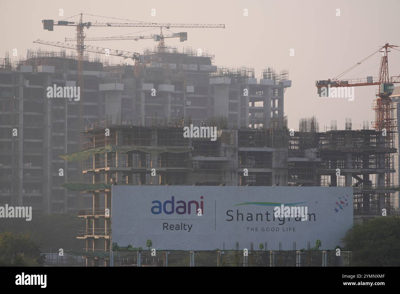 Construction workers work at a construction site of Adani group near ...