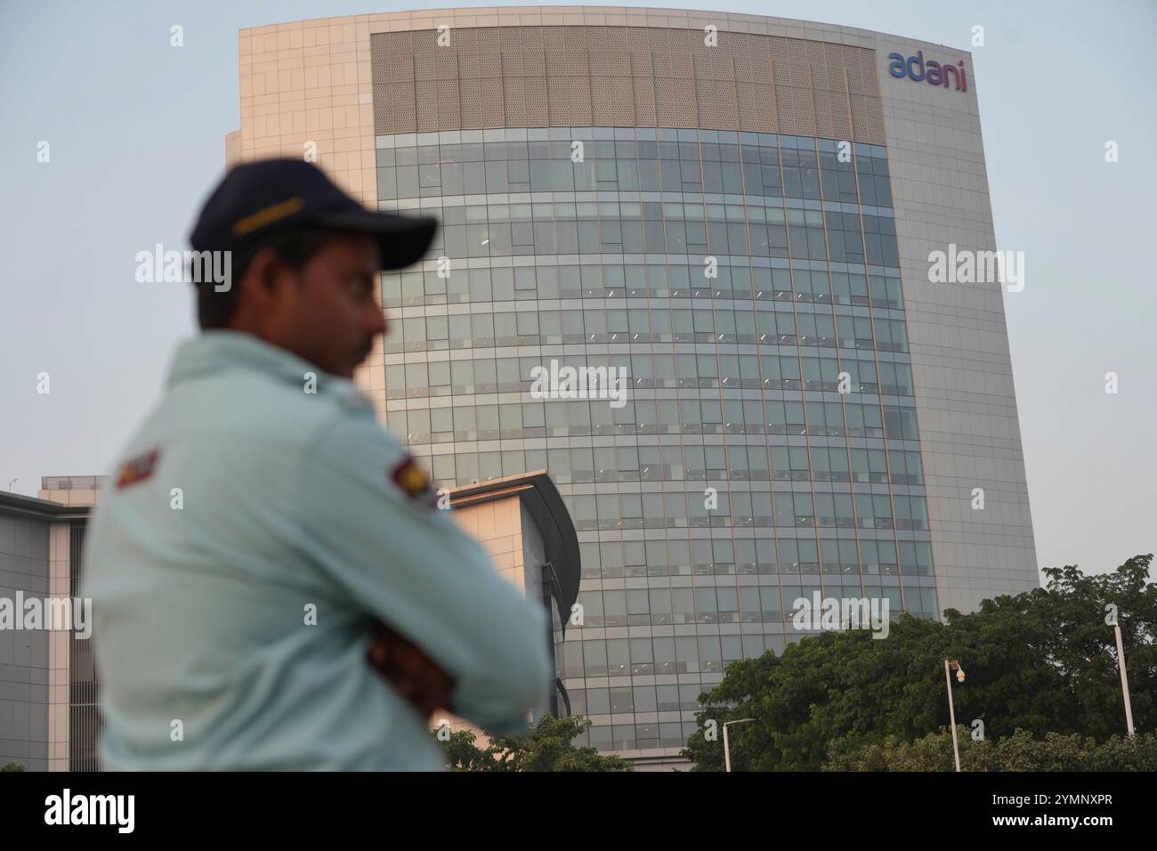 A security guard of a construction site stands near Adani Corporate ...