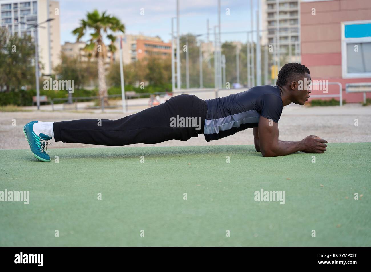 Young black man doing calisthenics plank in a park Stock Photo - Alamy