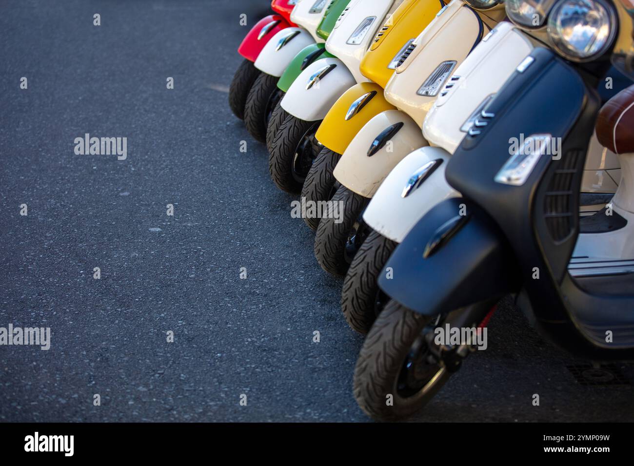 New retro motor scooters parked side by side on a street. Vibrant ...