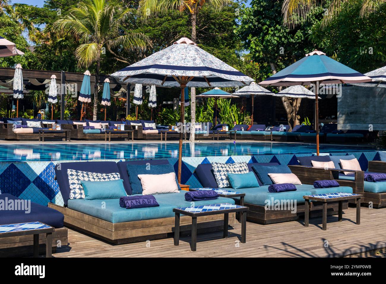 Blue deck chairs and parasols at Manarai Beach House, Sofitel, Nusa Dua ...