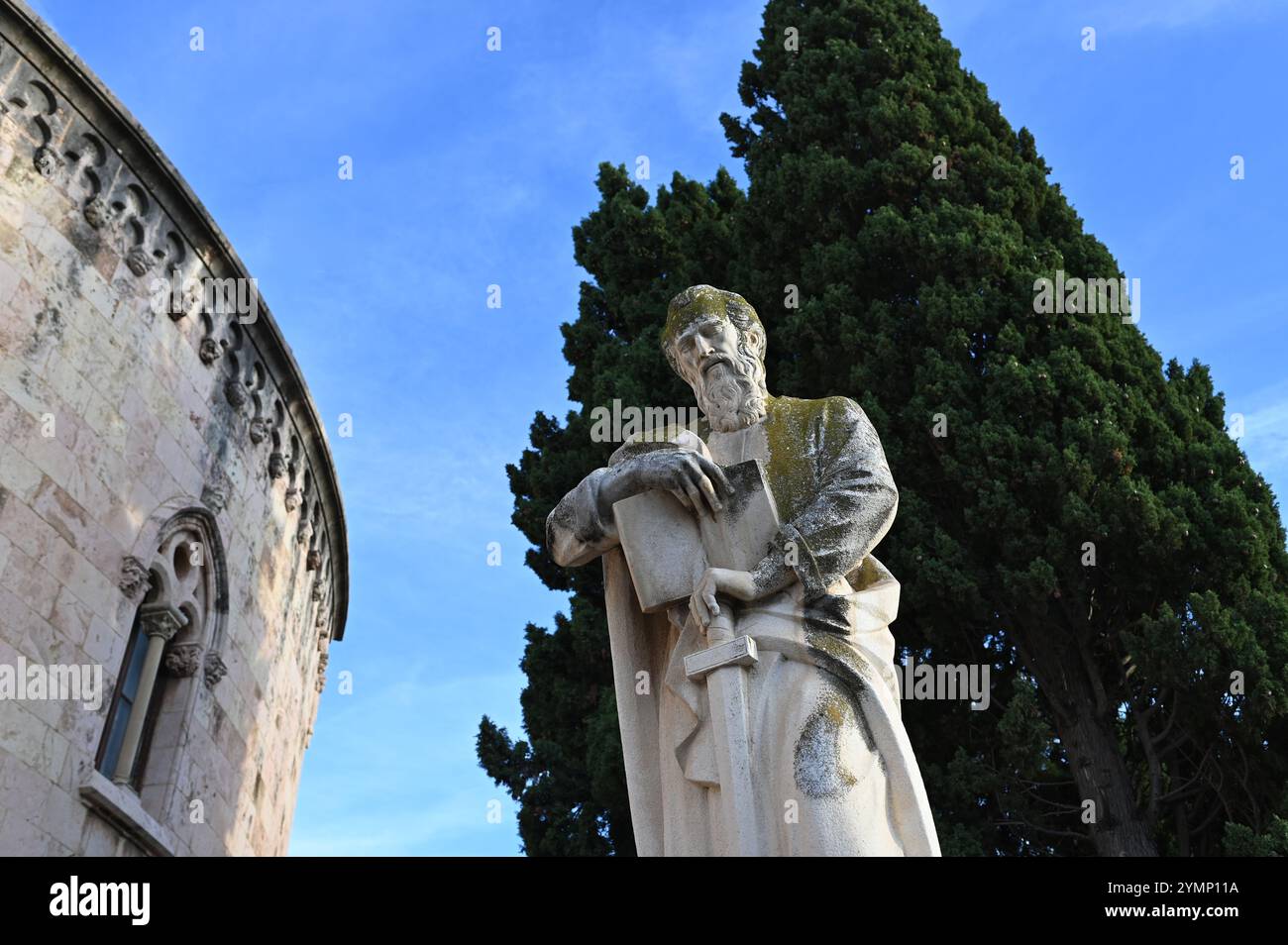 The Apostle Paul statue in Tarragona, surrounded by greenery, moss, and ...