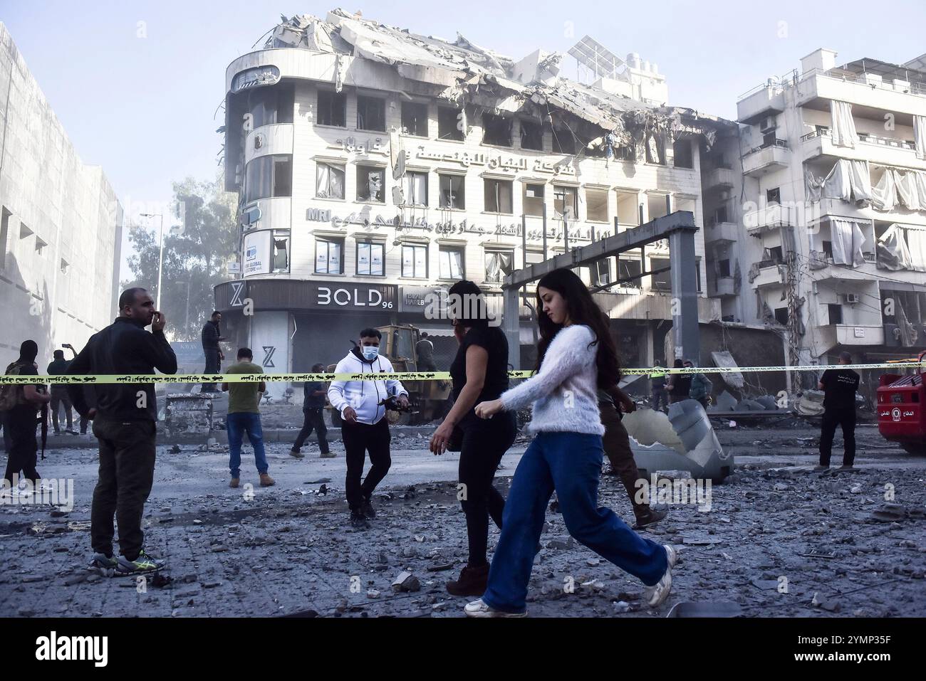 Beirut, Lebanon. 22nd Nov, 2024. Lebanese people walk past a damaged ...