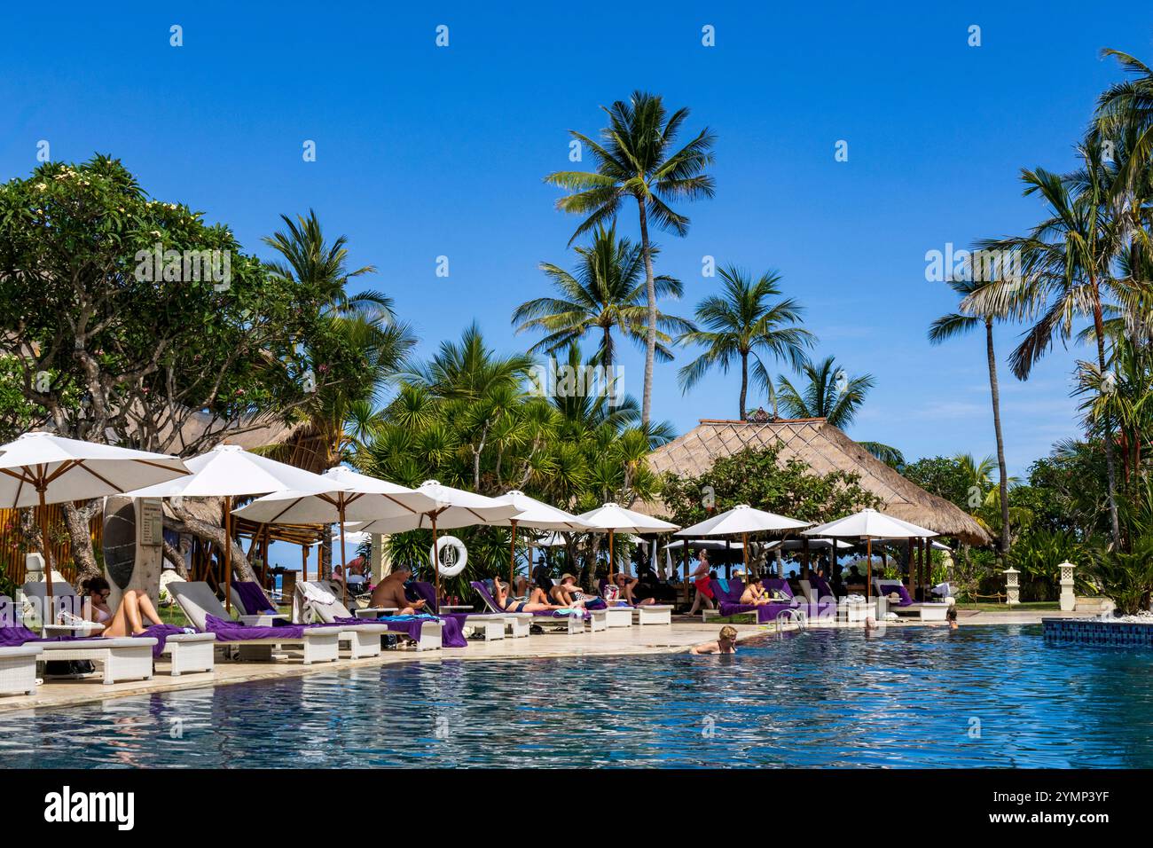 Holiday makers by the swimming pool, Nusa Dua Beach Hotel and Spa, Nusa ...