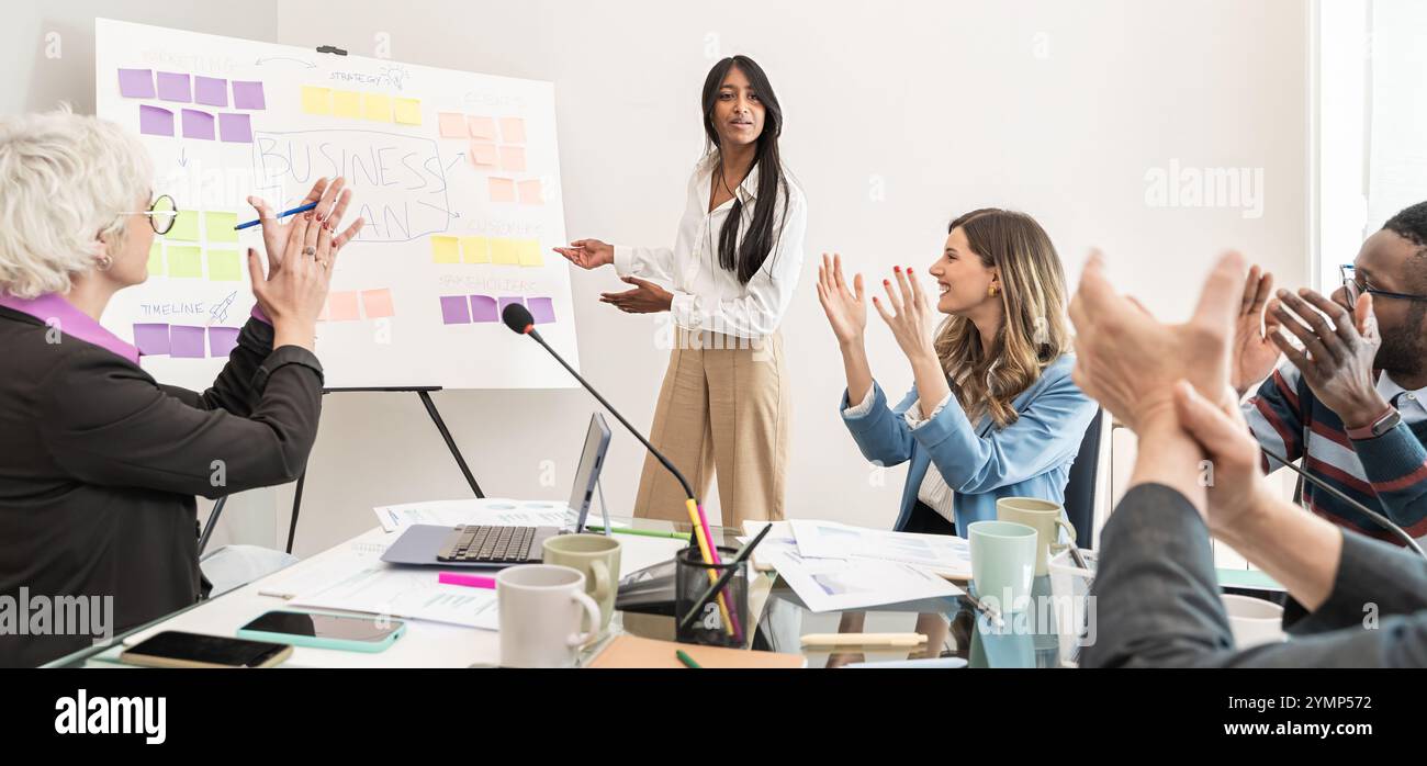 Enthusiastic diverse business team celebrating success during strategy ...