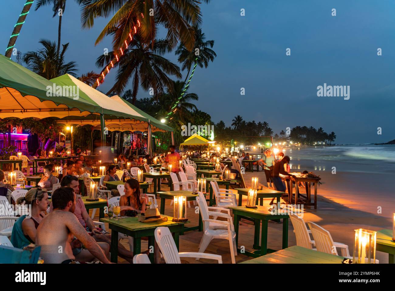 Restaurants on beach at dusk, Mirissa, South Coast, Sri Lanka Stock ...