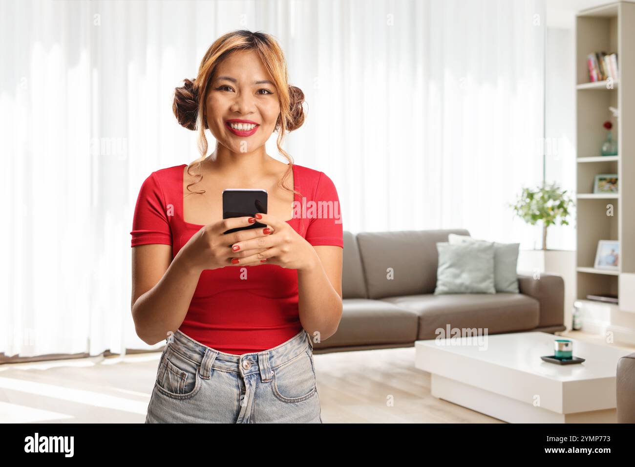 Happy filipina woman using a smartphone at home Stock Photo - Alamy