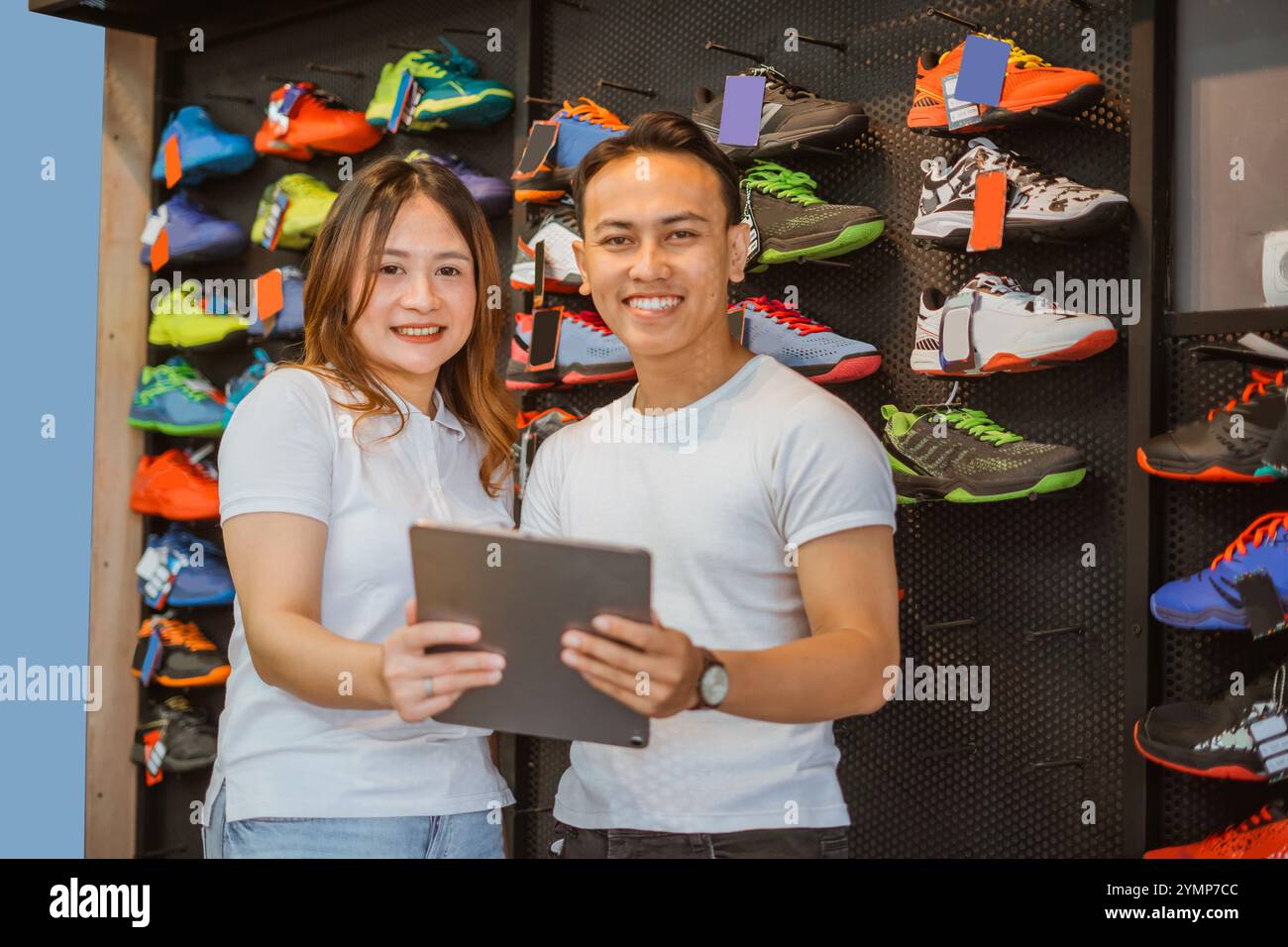 sneakers store workers holding tablet checking inventory Stock Photo ...