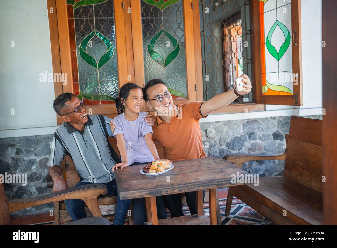 family grandchild grandfather father taking picture together Stock ...