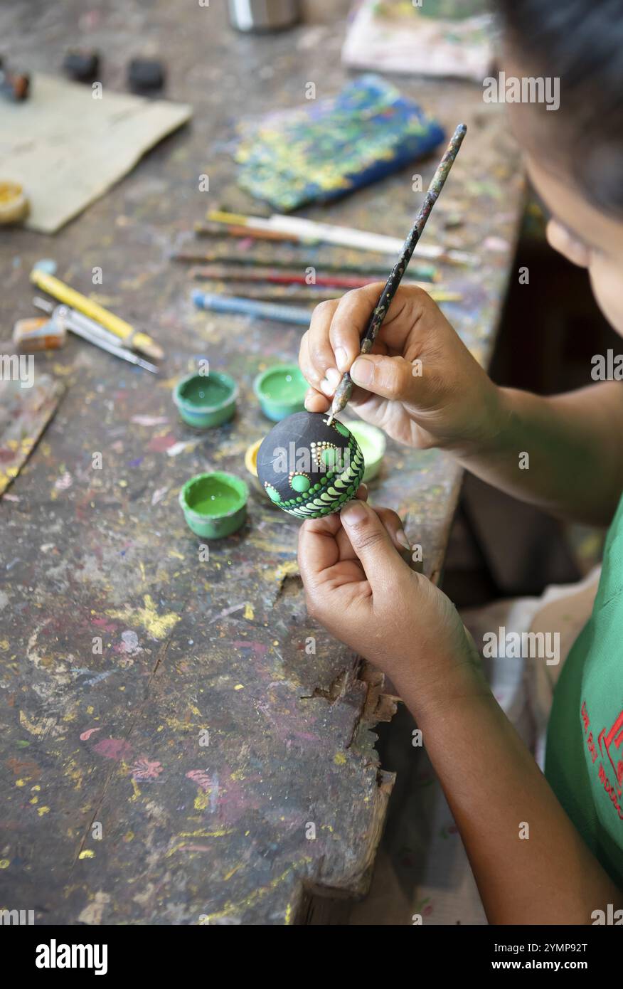 Sri Lankan woman painting a wooden ball, Oak Ray Woodcarvings, Naula ...