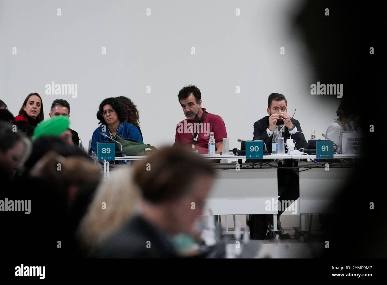 People gather in a meeting room at the COP29 U.N. Climate Summit ...