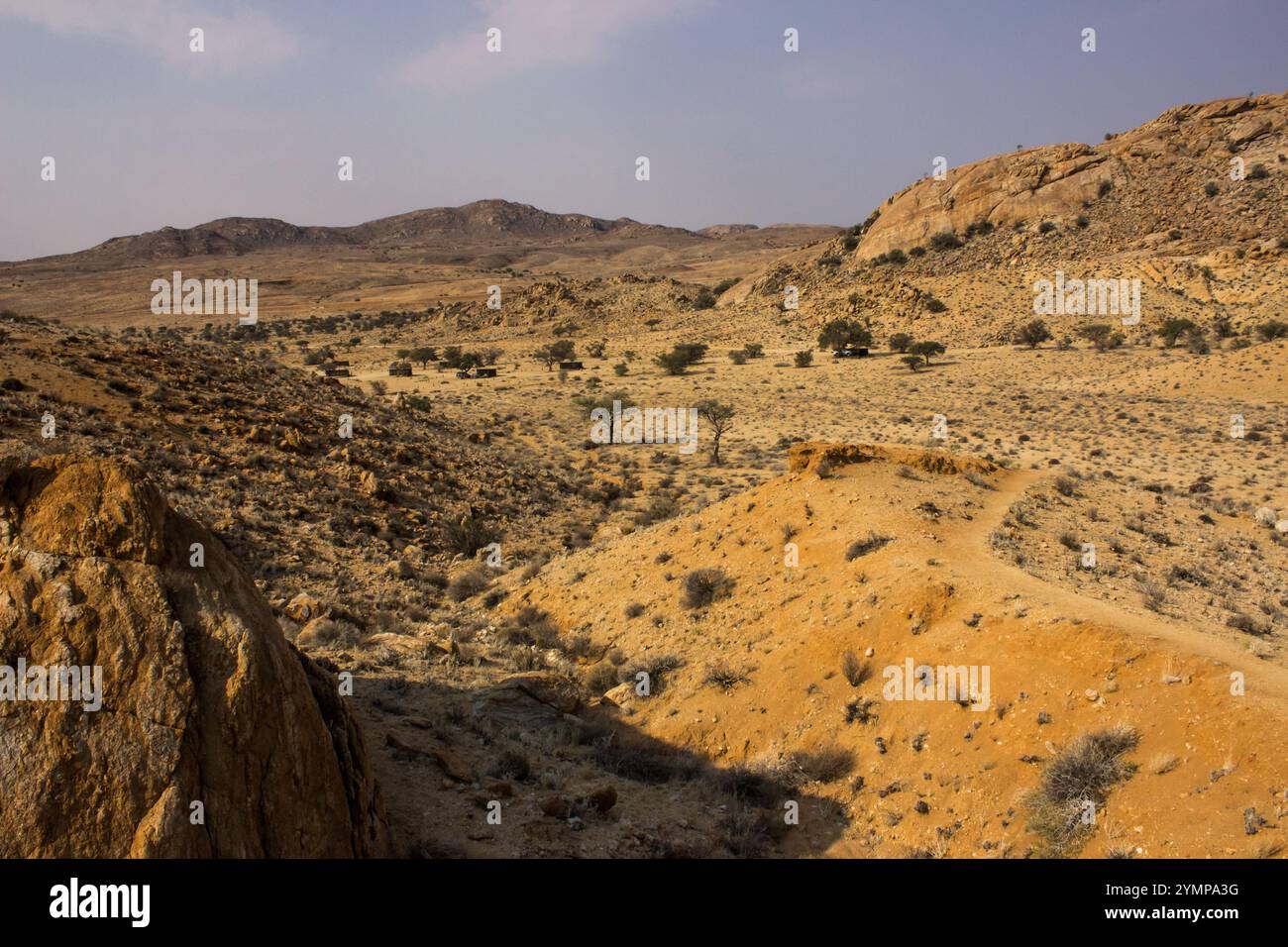 Trail going into the arid and rocky environment among the Granite hills ...