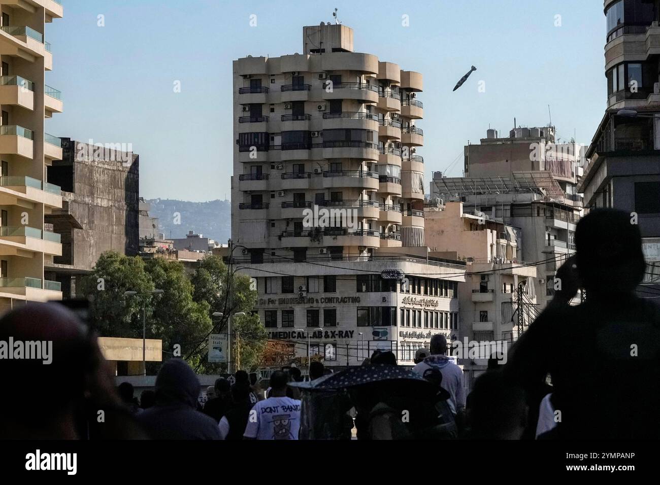 People look as a munition launched by Israeli forces makes its way to ...