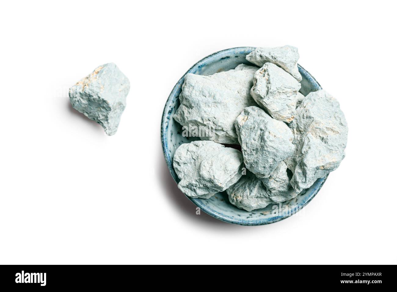 Piece of edible kaolin clay in bowl isolated on white background, top ...