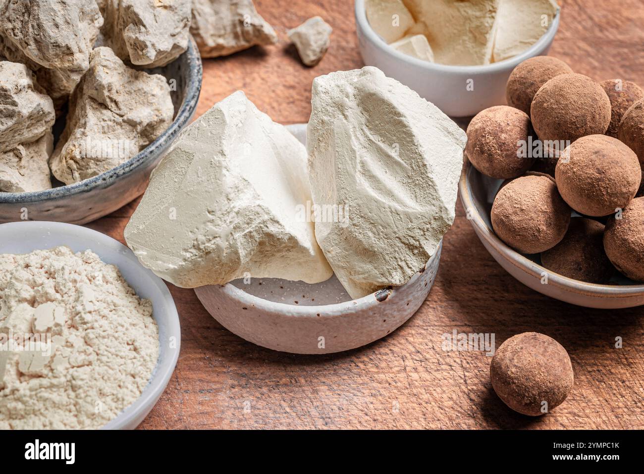 Edible caramel Clay Stones, clay rocks and powder on wooden table close ...