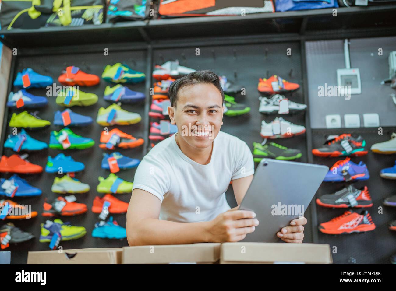 smiling asian male staff holding tablet Stock Photo - Alamy