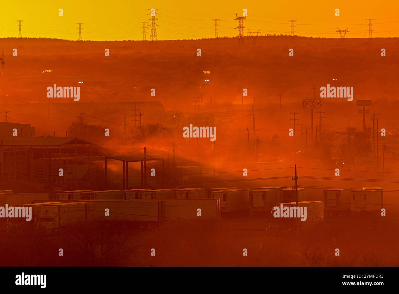 Trucks and trailers and electric light towers at dusk in Hermosillo ...