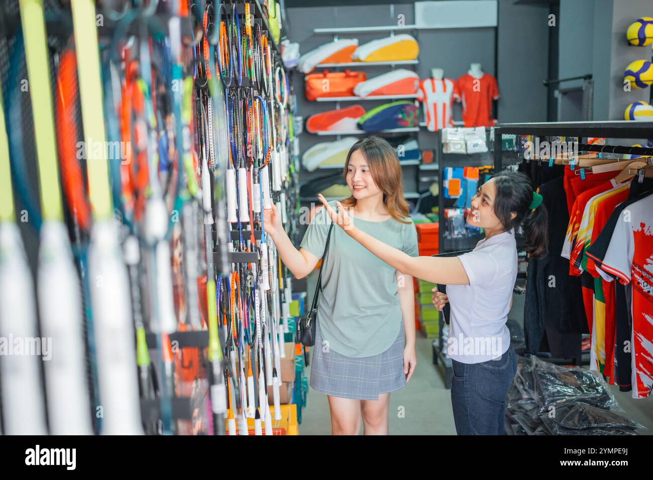 sports store saleswoman showing display badminton racket Stock Photo ...