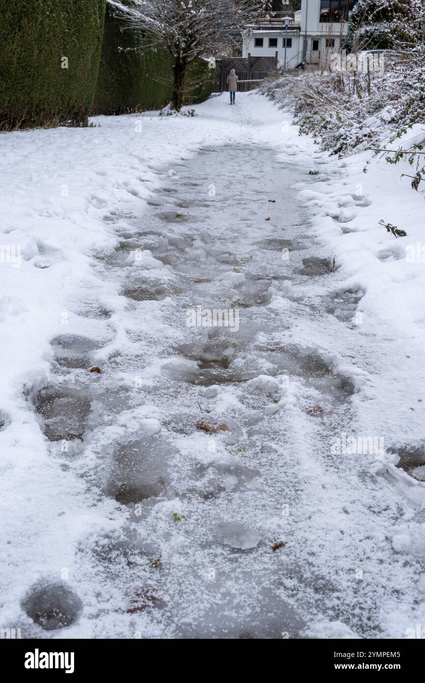 A person walking on a icy path in Chamonix after the first snow in ...