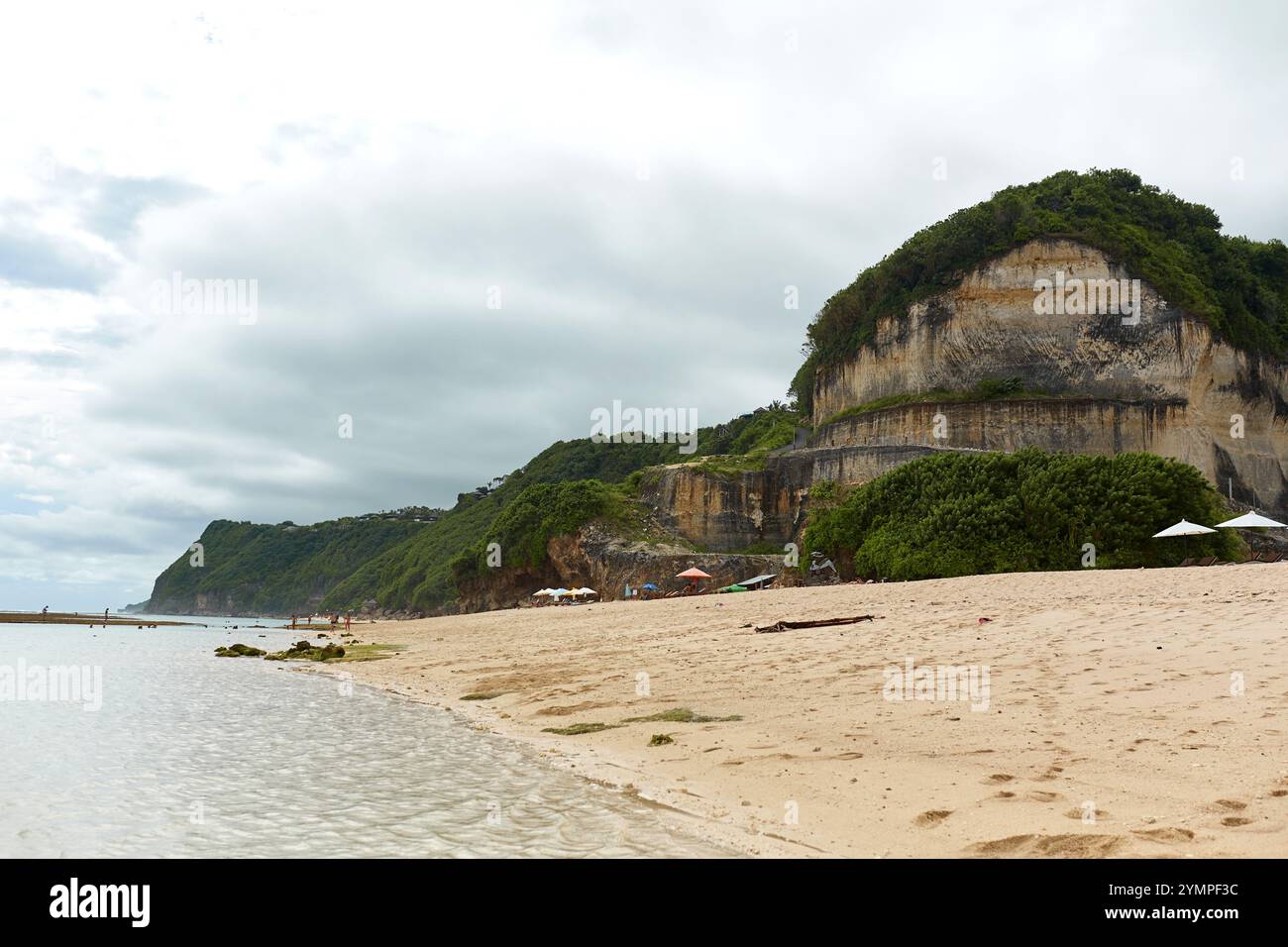 An incredibly beautiful deserted tropical beach under a cliff with ...