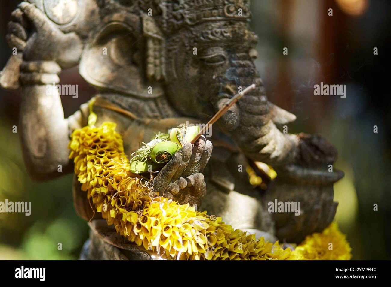 Sculpture of a temple with flowers and incense for ritual offerings on ...