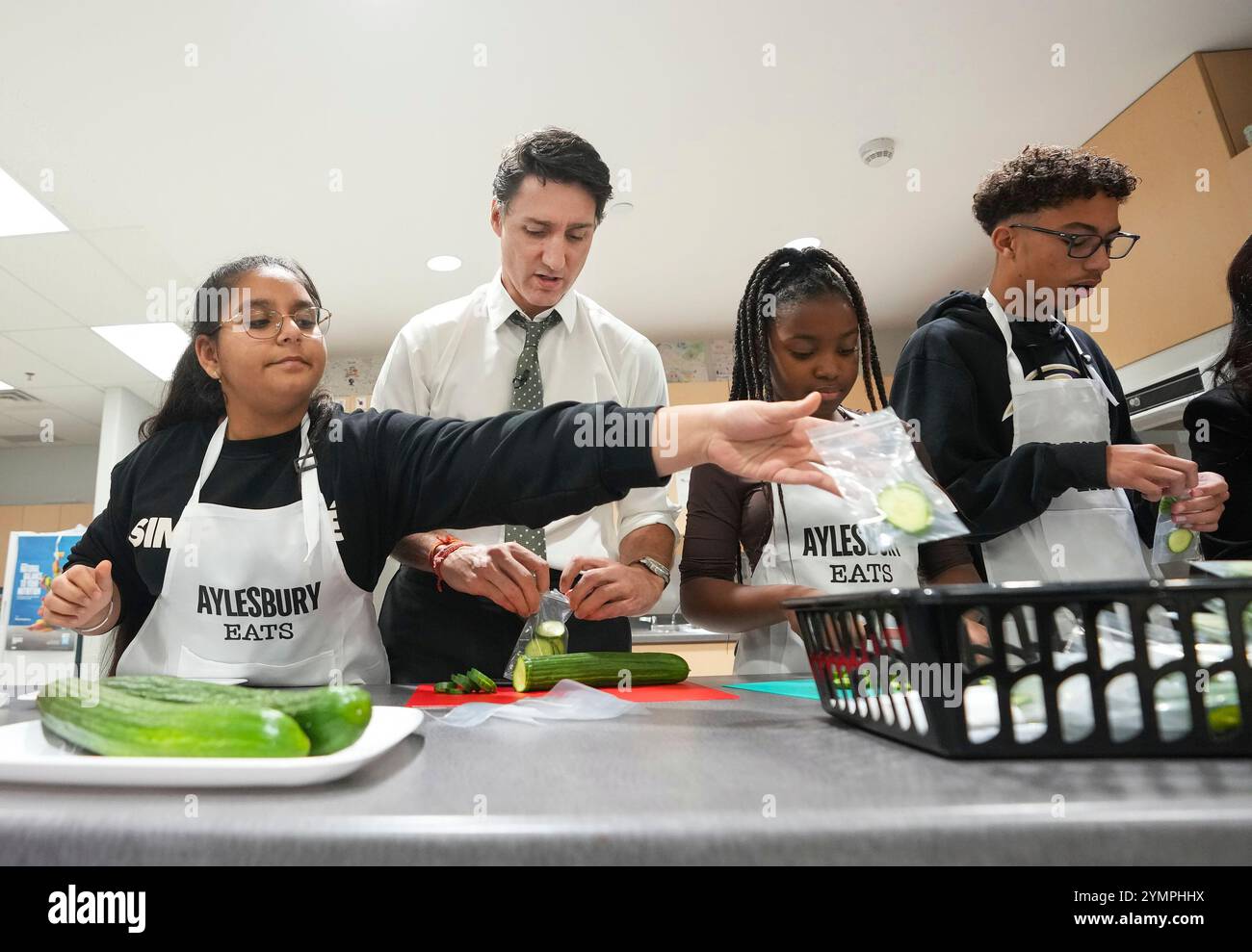 Canada Prime Minister Justin Trudeau, center, helps pack lunches as ...