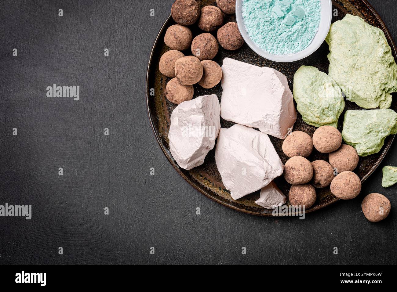 Edible various Clay Stones, clay rocks and powder on black background ...