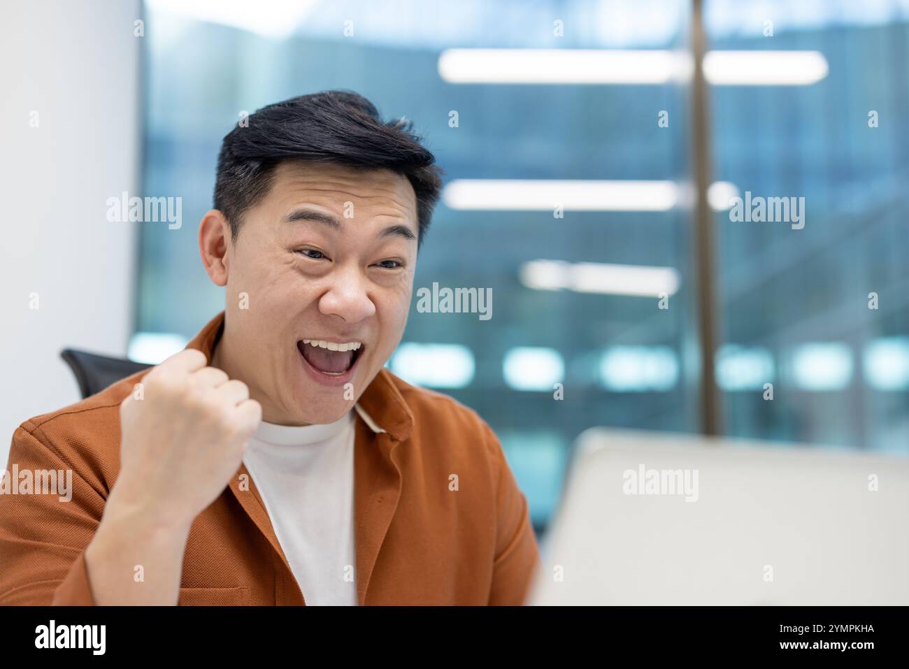 Asian man businessman showing excitement celebrating success at work ...
