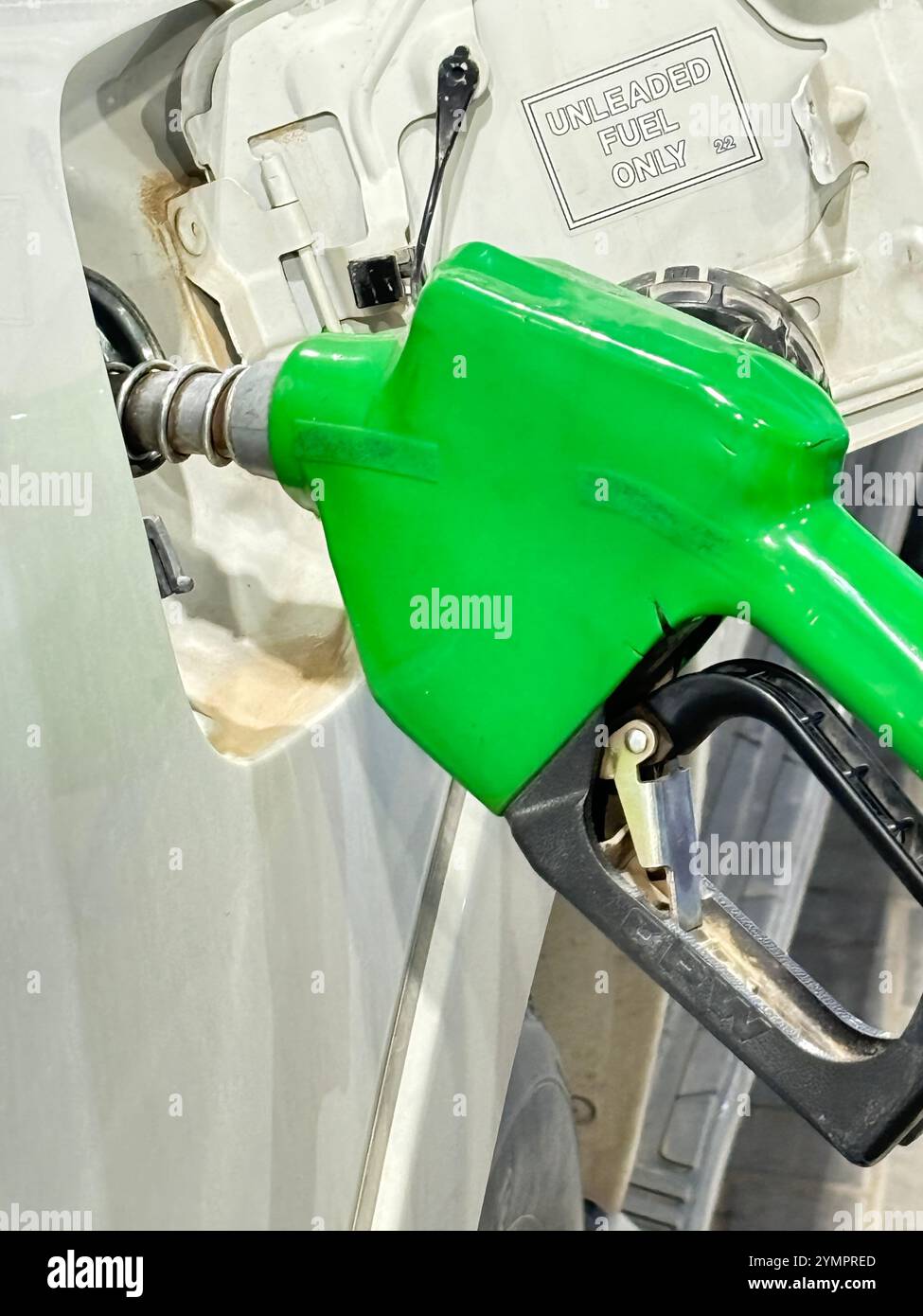 Green gas pump nozzle with unleaded fuel only sign Stock Photo - Alamy