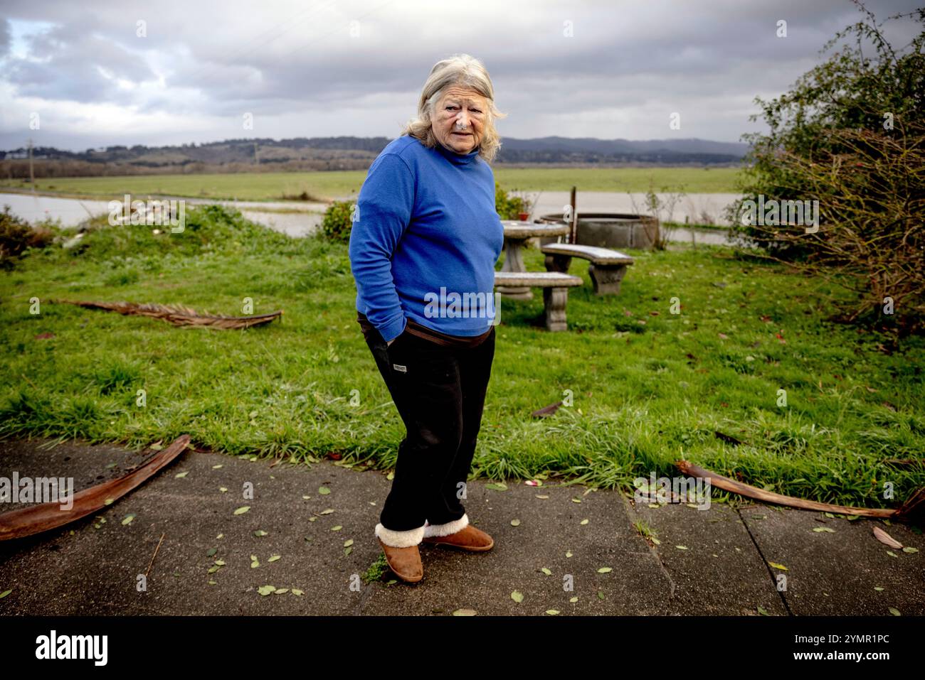 Sharon Scofield, 71, checks the debris in her front yard after winds ...