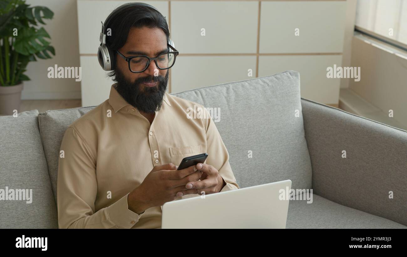 Arabian Indian businessman man multitasking working with devices at home muslim guy in ...