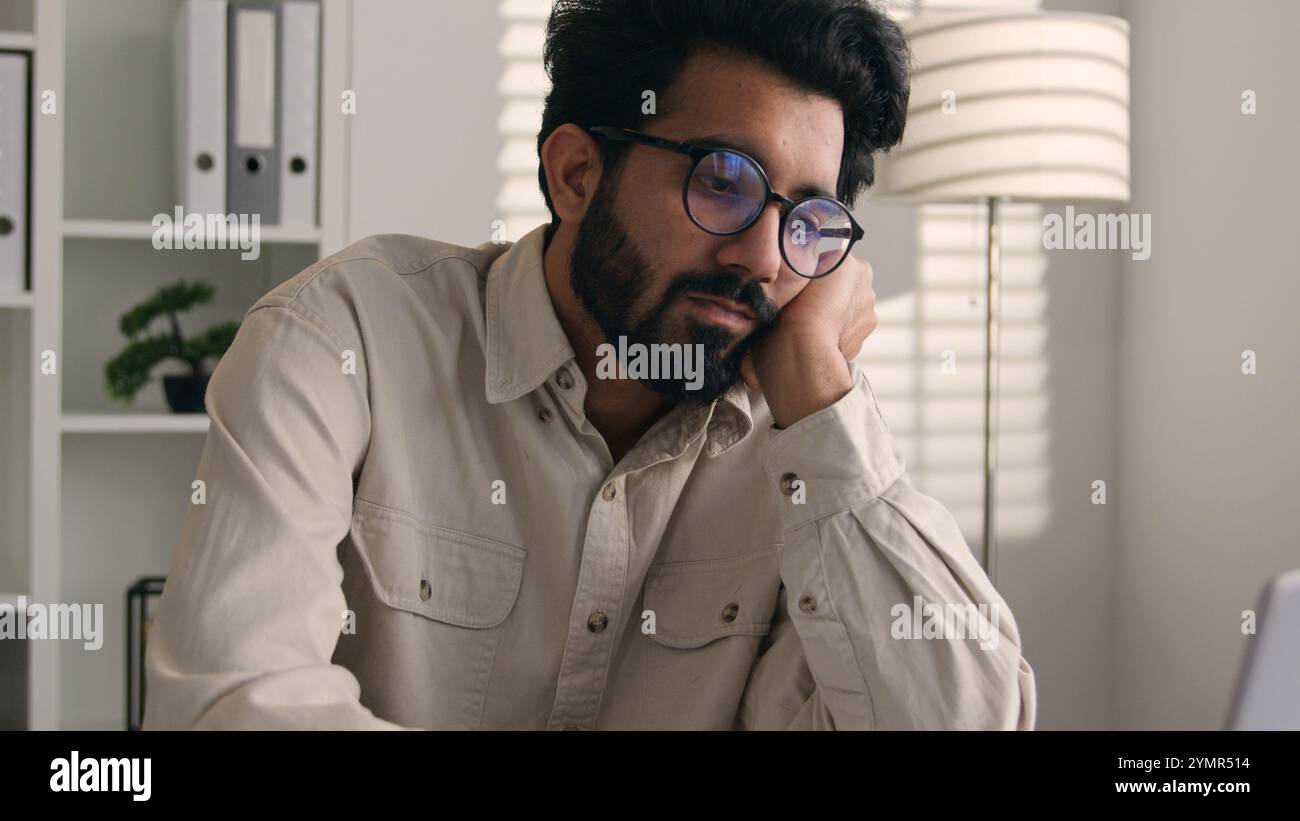 Tired exhausted weary Arabian Indian businessman bored employee ...