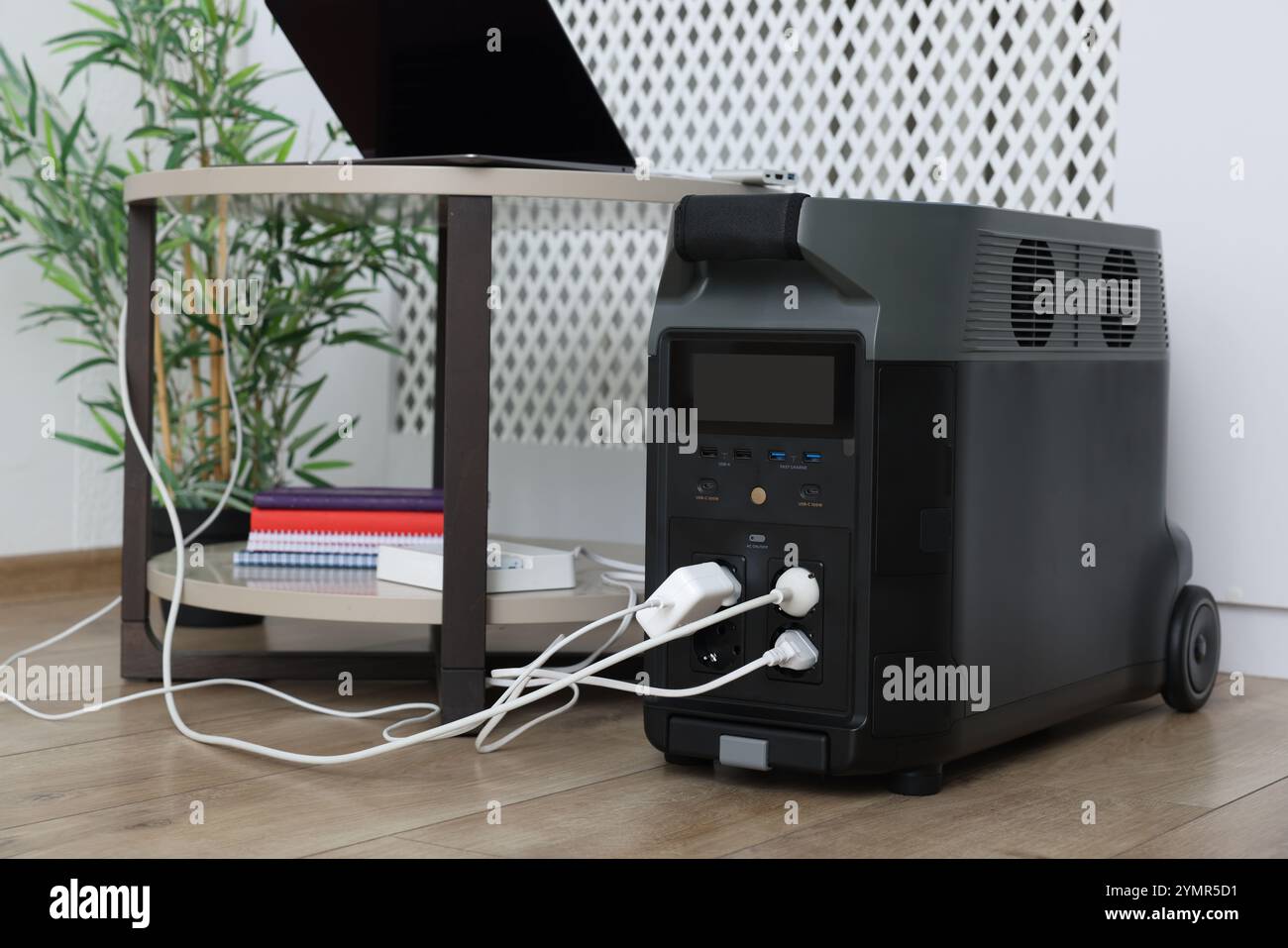 Modern portable power station, charging attached devices indoors Stock ...