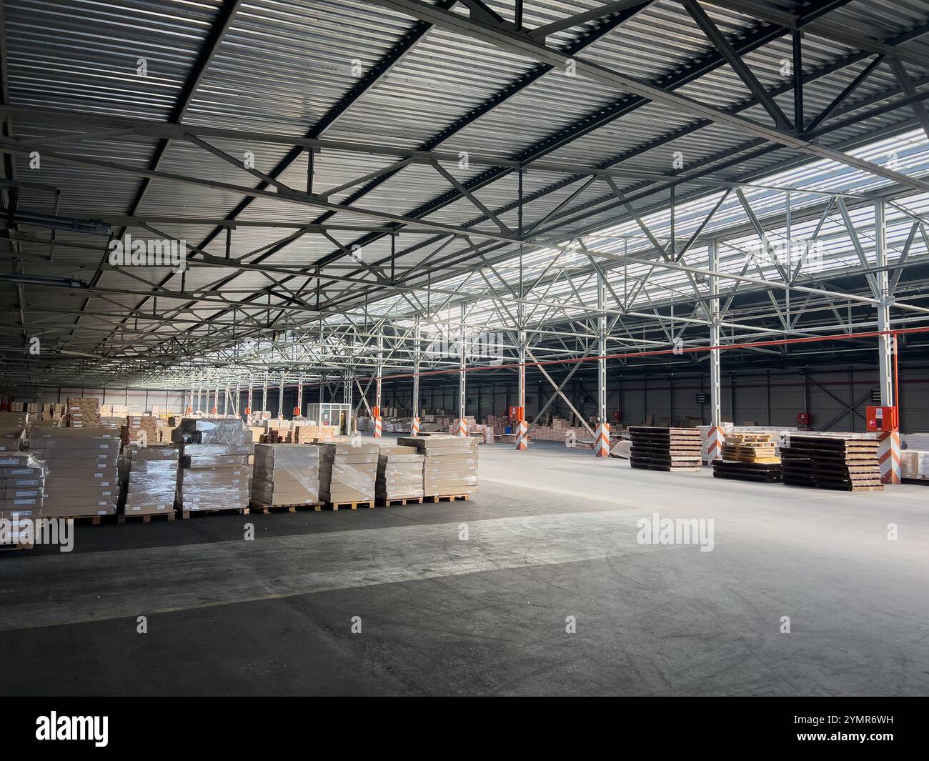A spacious warehouse interior with neatly stacked pallets of goods on ...