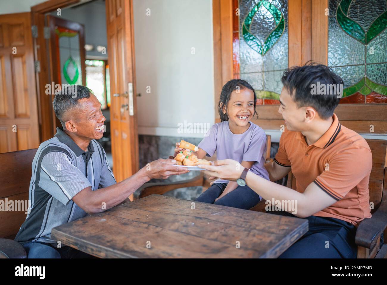 adorable kid taking snack from grandfather Stock Photo - Alamy