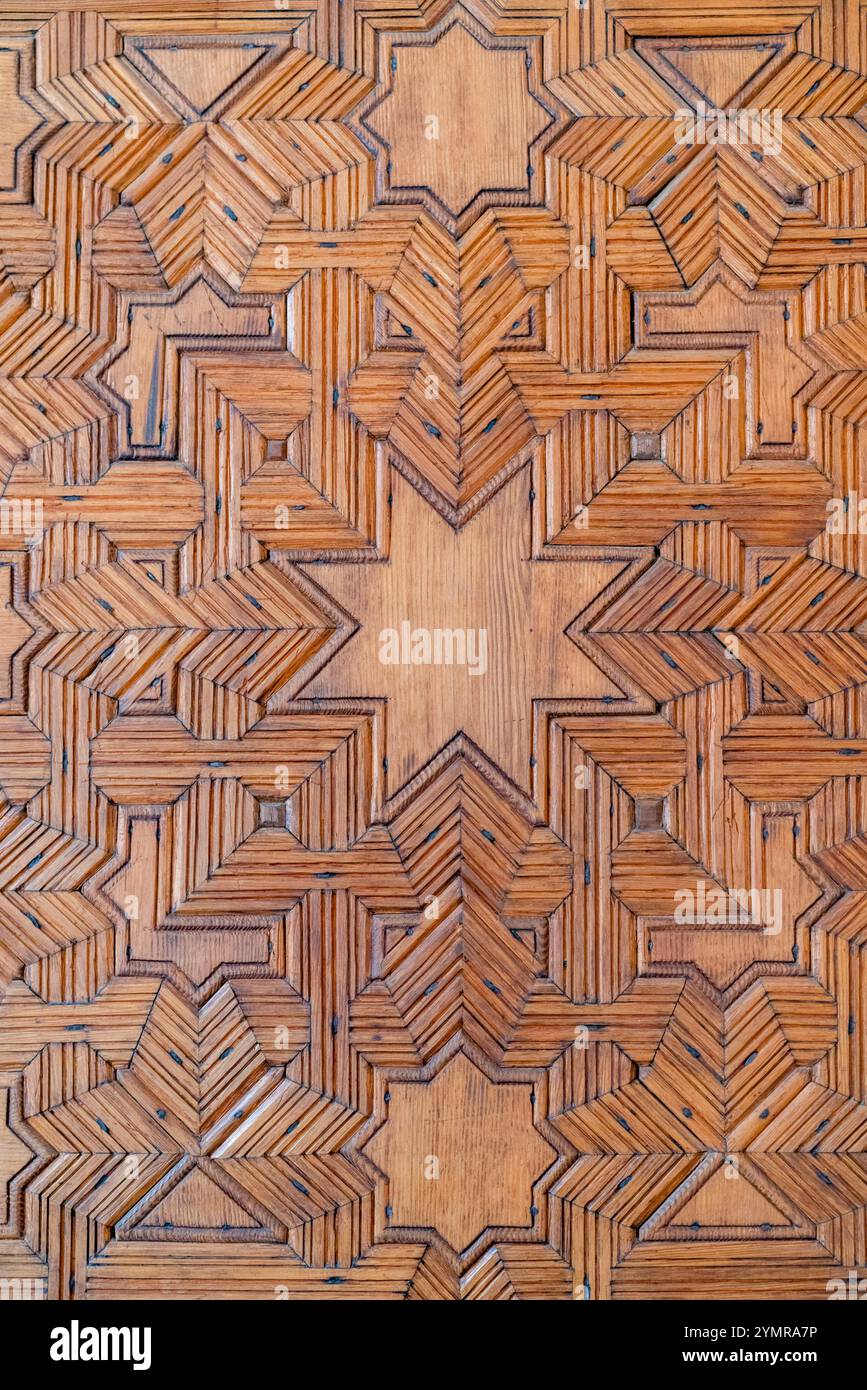 Detail of a carved wooden door in the Alhambra, Granada, Spain. Rab ...