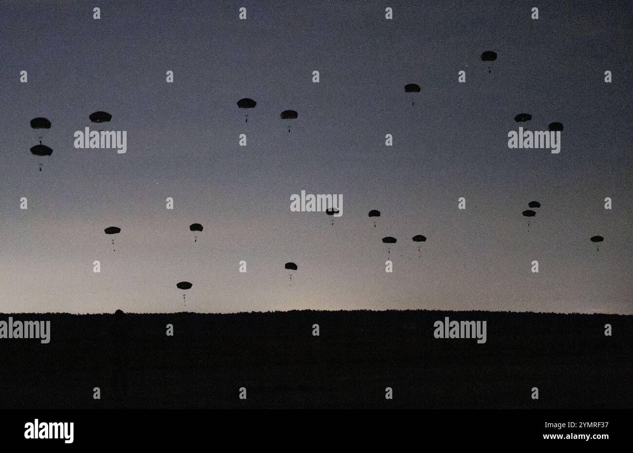 U.S. Army 82nd Airborne Division paratroopers deploy their parachutes ...