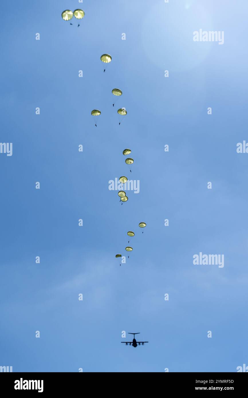 Static line jumpers float through the skies above Sainte-Mere-Eglise ...