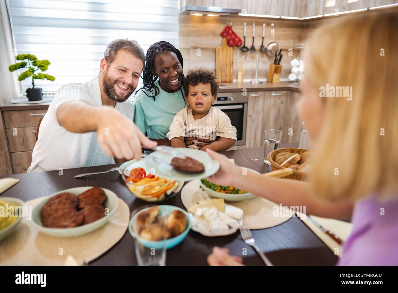 Family enjoys meal together home hi-res stock photography and images ...