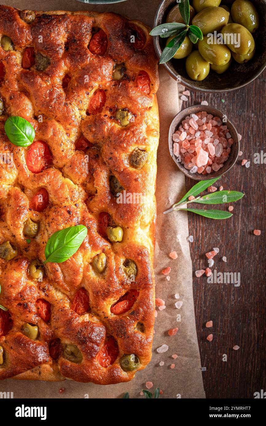 Traditional focaccia made of flour, cherry tomatoes and olives. Poster ...