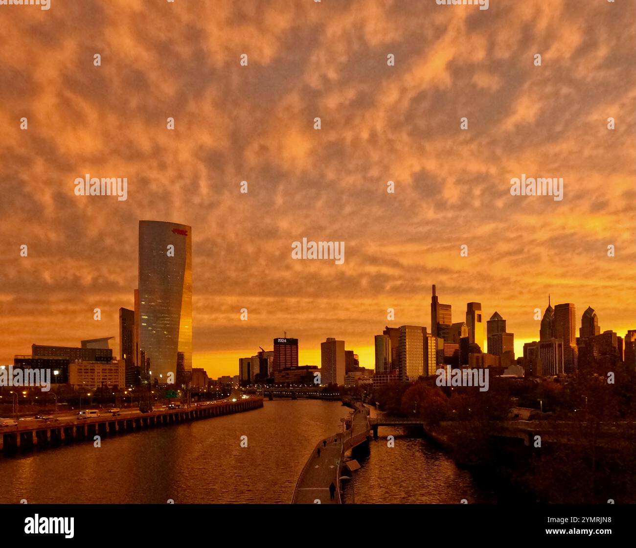Sunrise lights up the clouds above the Philadelphia skyline, as seen ...